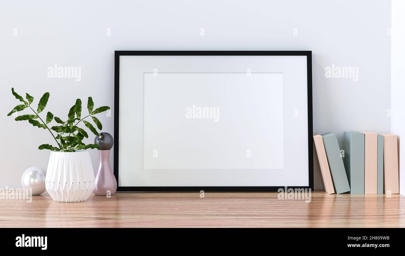 A picture frame on the floor with a flower vase Stock Photo - Alamy