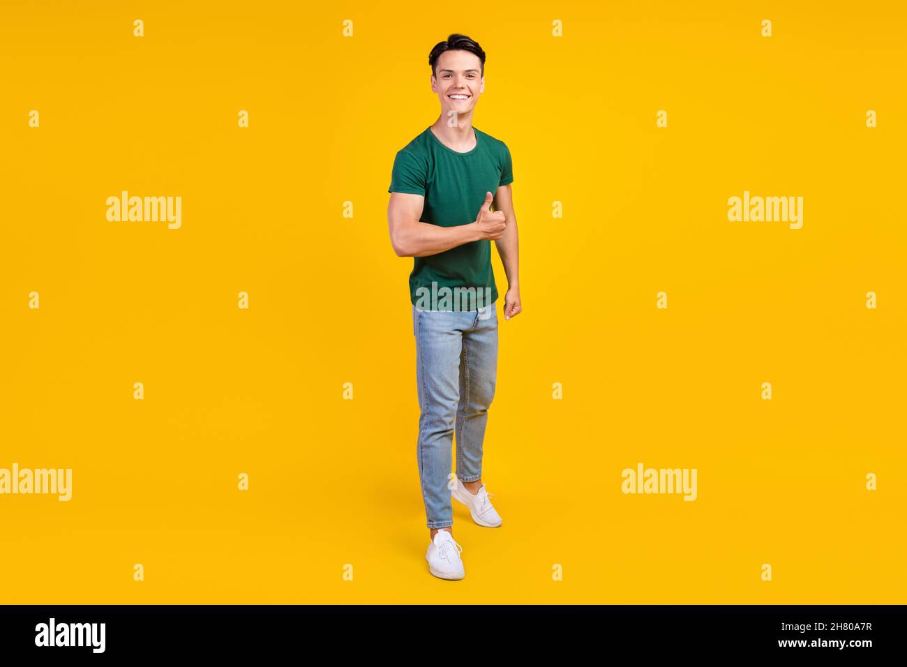 Full body photo of cheerful happy positive man hold hand thumb up smile ...