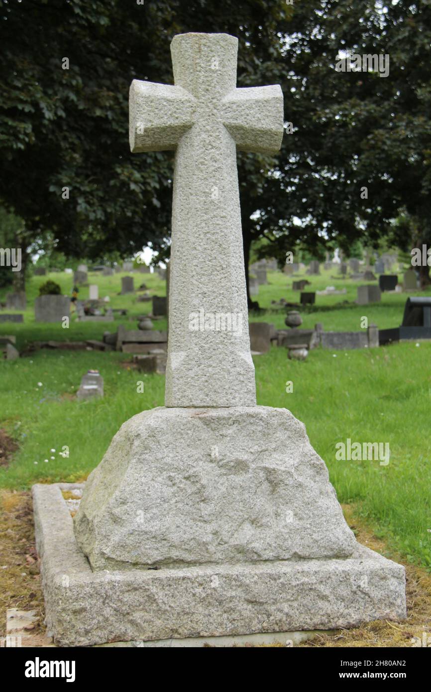 A Stone Cross on a Plinth at a Grave in a Cemetery Stock Photo - Alamy