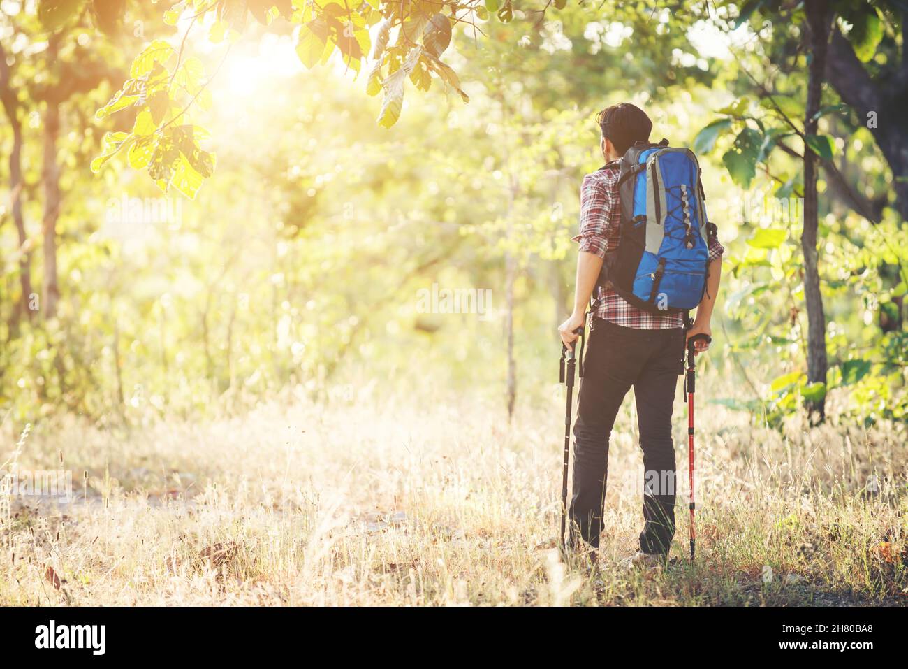 Young hipster man walking on the rural road during hikes on vacation ...