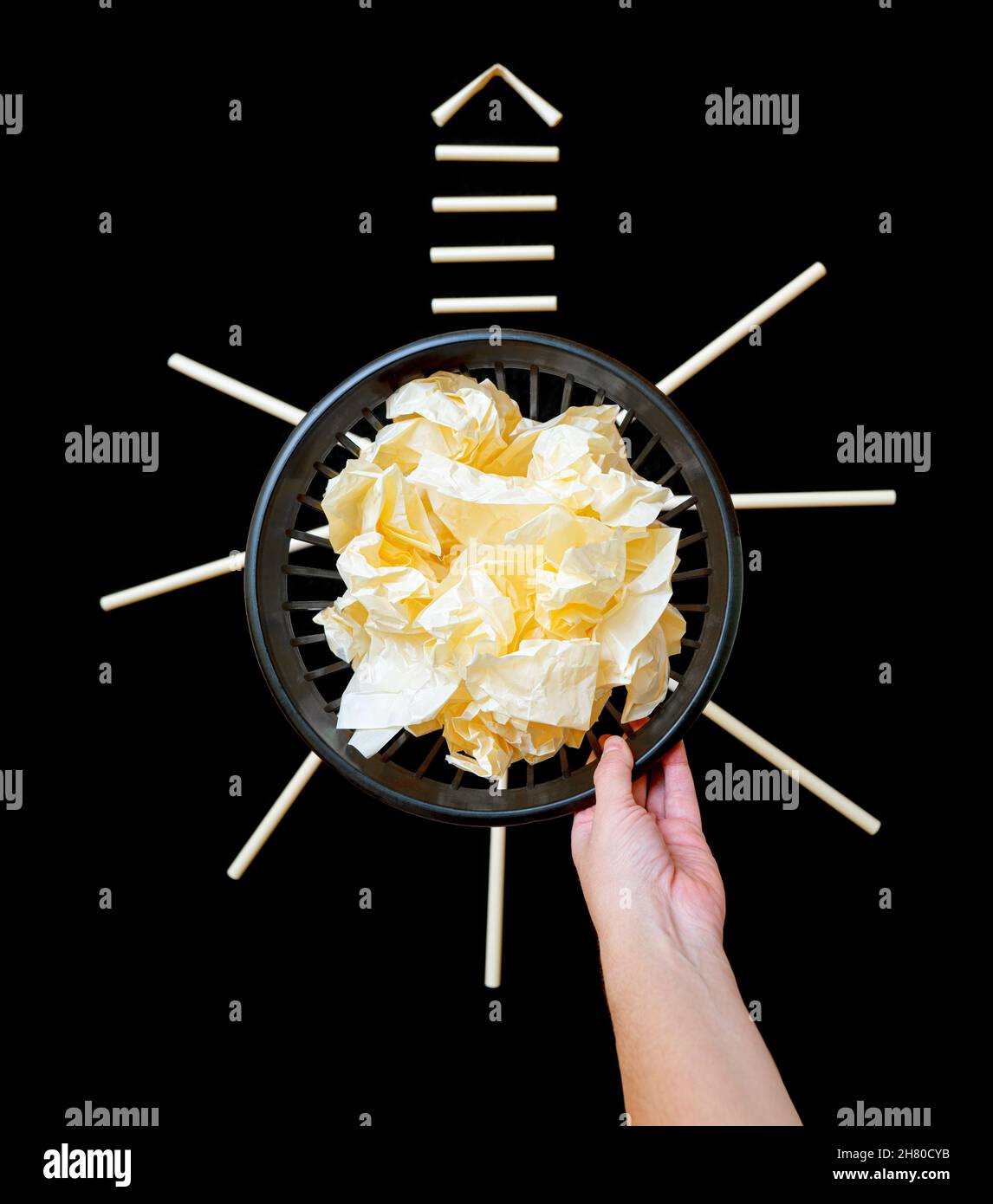 Light bulb symbol made out of an office bin full of crumpled paper ...