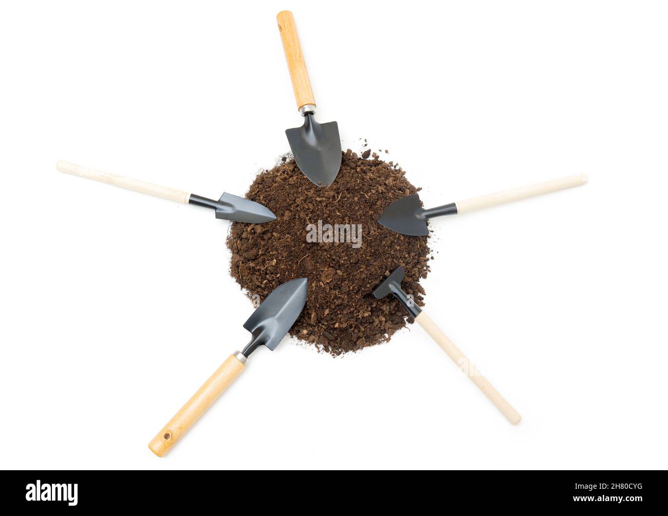 Selection of miniature garden hand tools in a soil pile isolated on ...