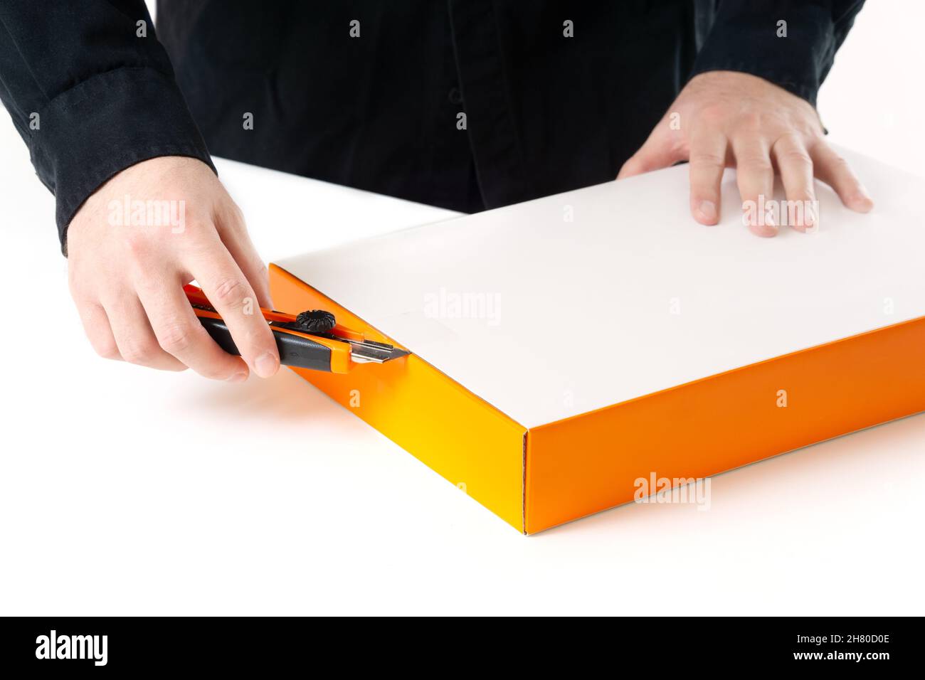 Man opening a box with a utility knife Stock Photo - Alamy