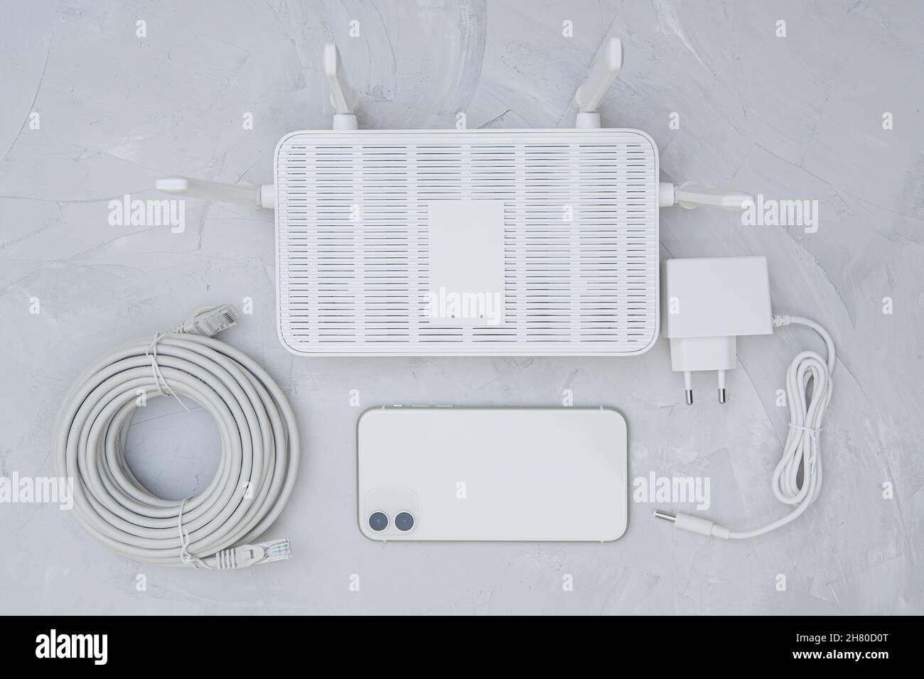 Wi-Fi 6 router with a power supply adapter, roll of ethernet cable and ...