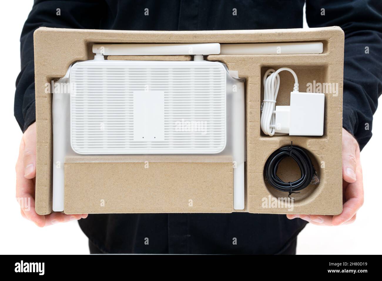 Man in black uniform showing a dual band Wi-Fi 6 router with ...