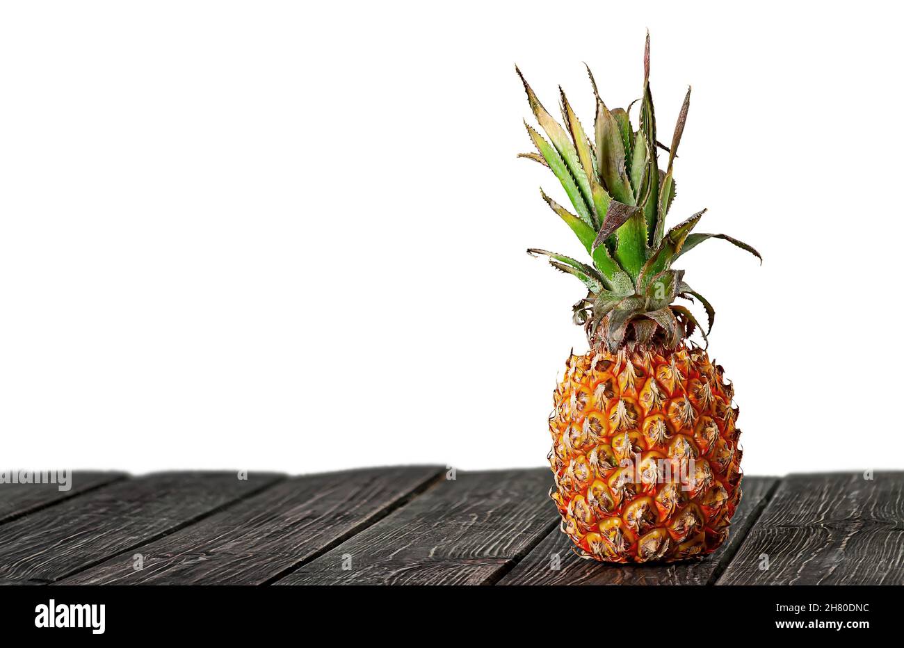 Pineapple stands on wooden boards isolated on white background Stock ...