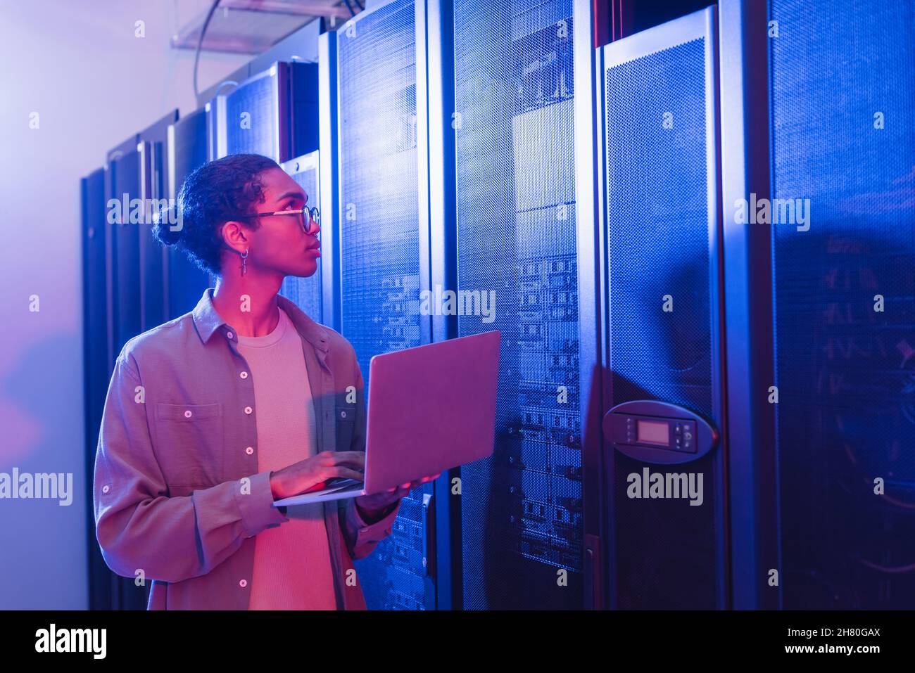 african american programmer with digital tablet working in data center in neon light Stock Photo ...