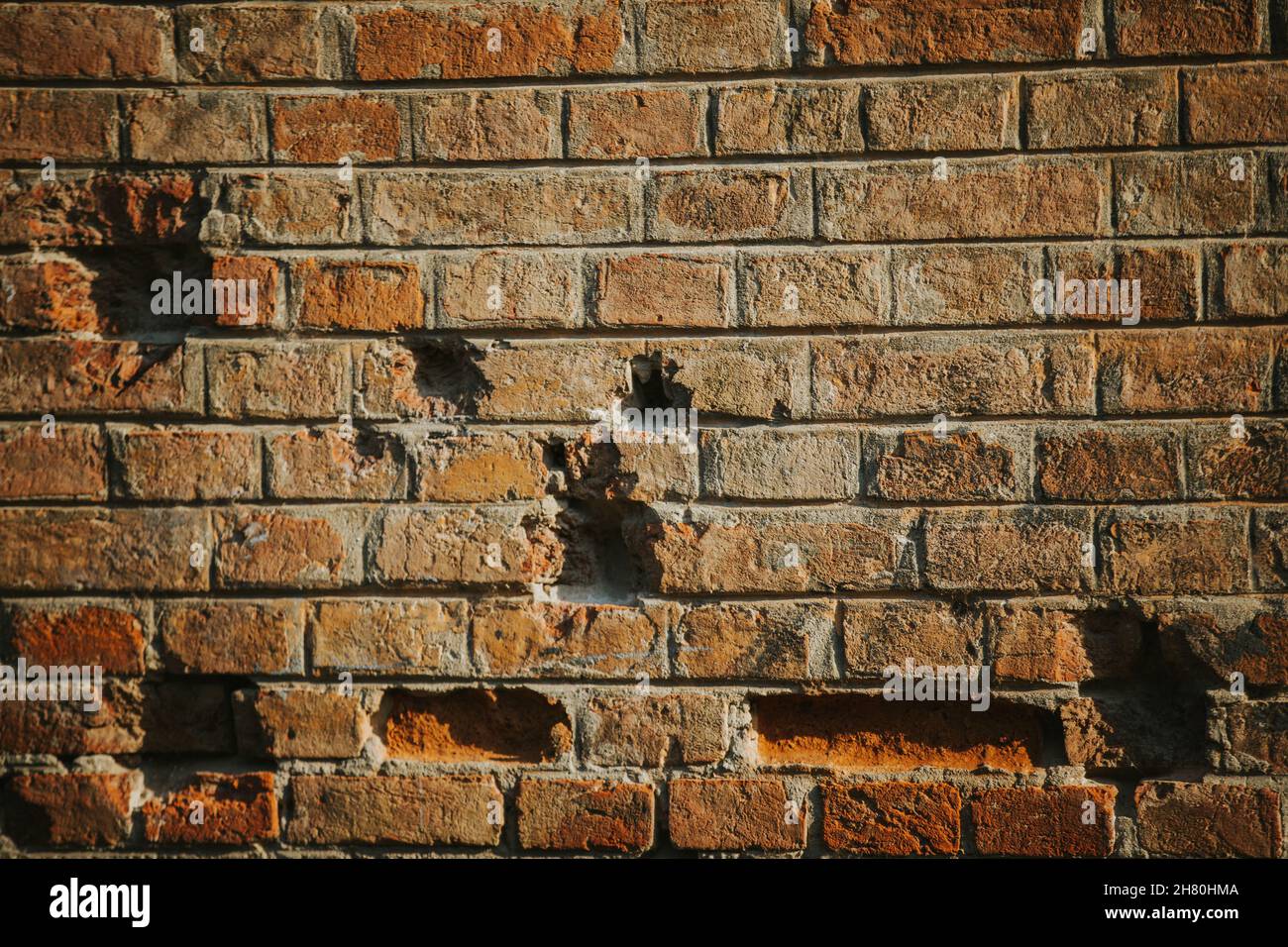 Closeup of an old aged brick wall texture with bricks missing from it ...