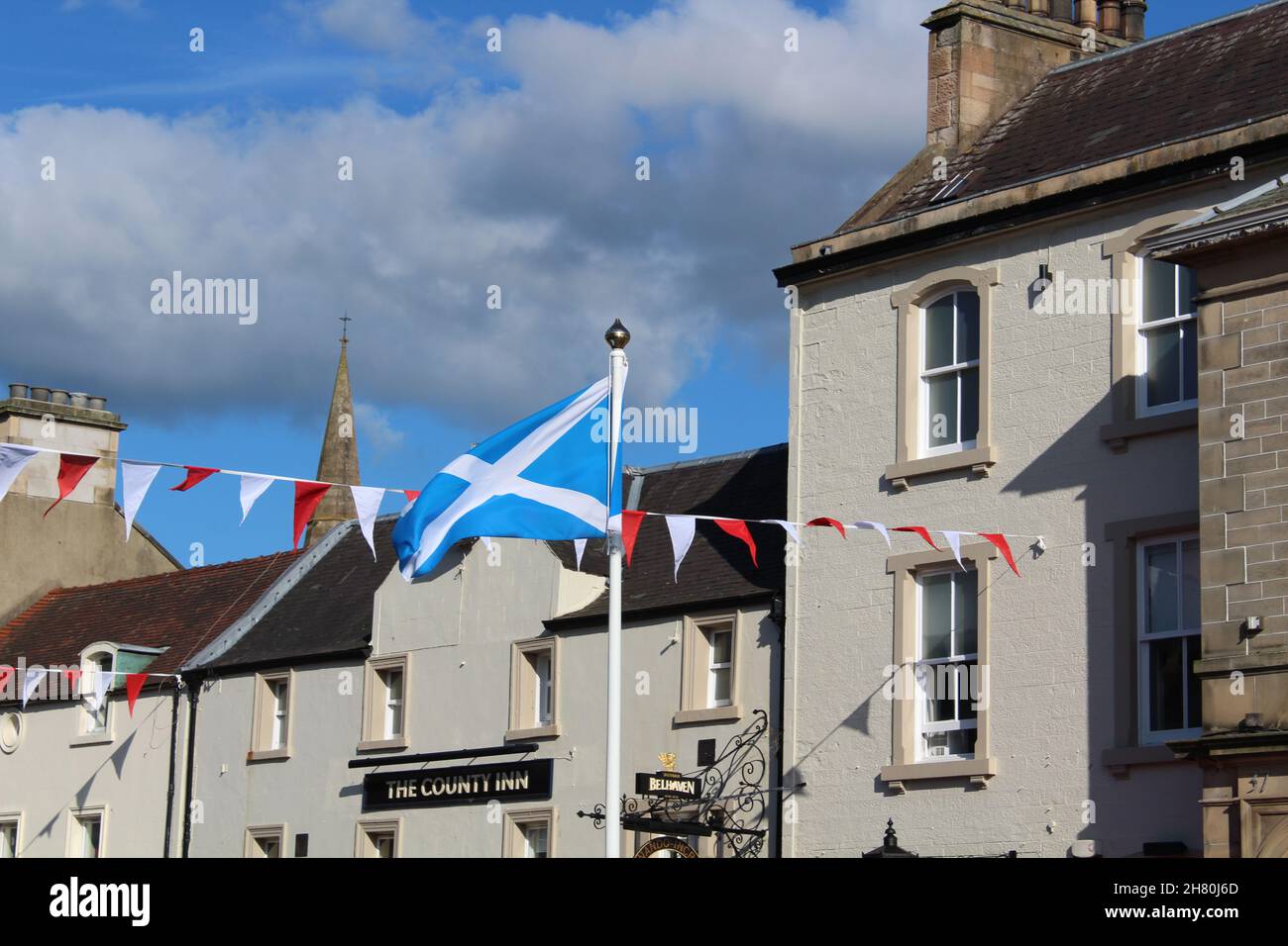 Scottish flag flying in the sun during Beltane in Peebles, Scotland ...