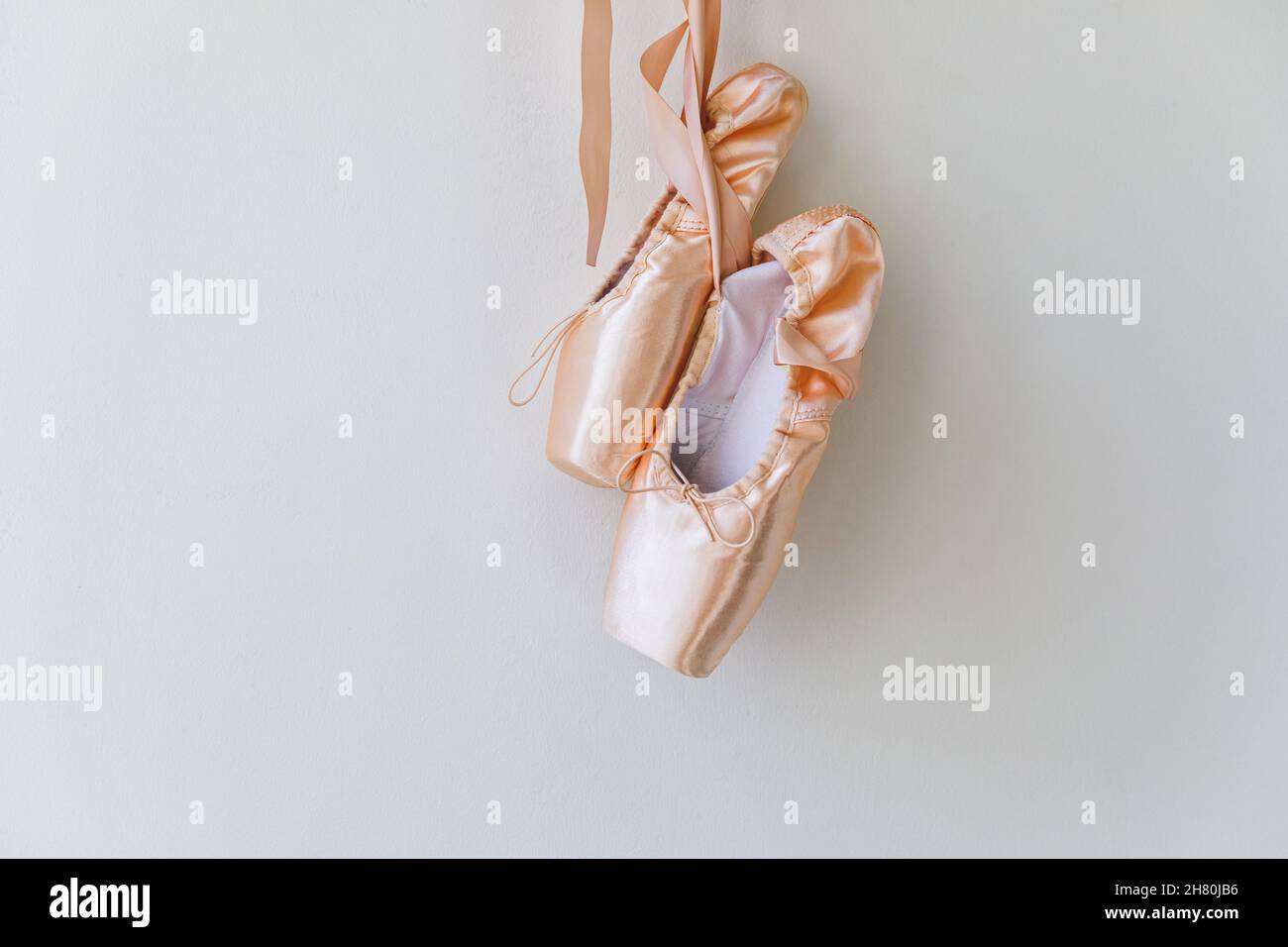 New pastel beige ballet shoes with satin ribbon isolated on white ...