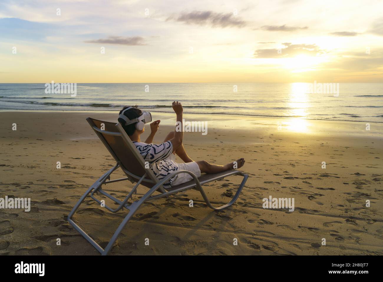 Young Asian man using virtual reality glasses for business meeting on ...