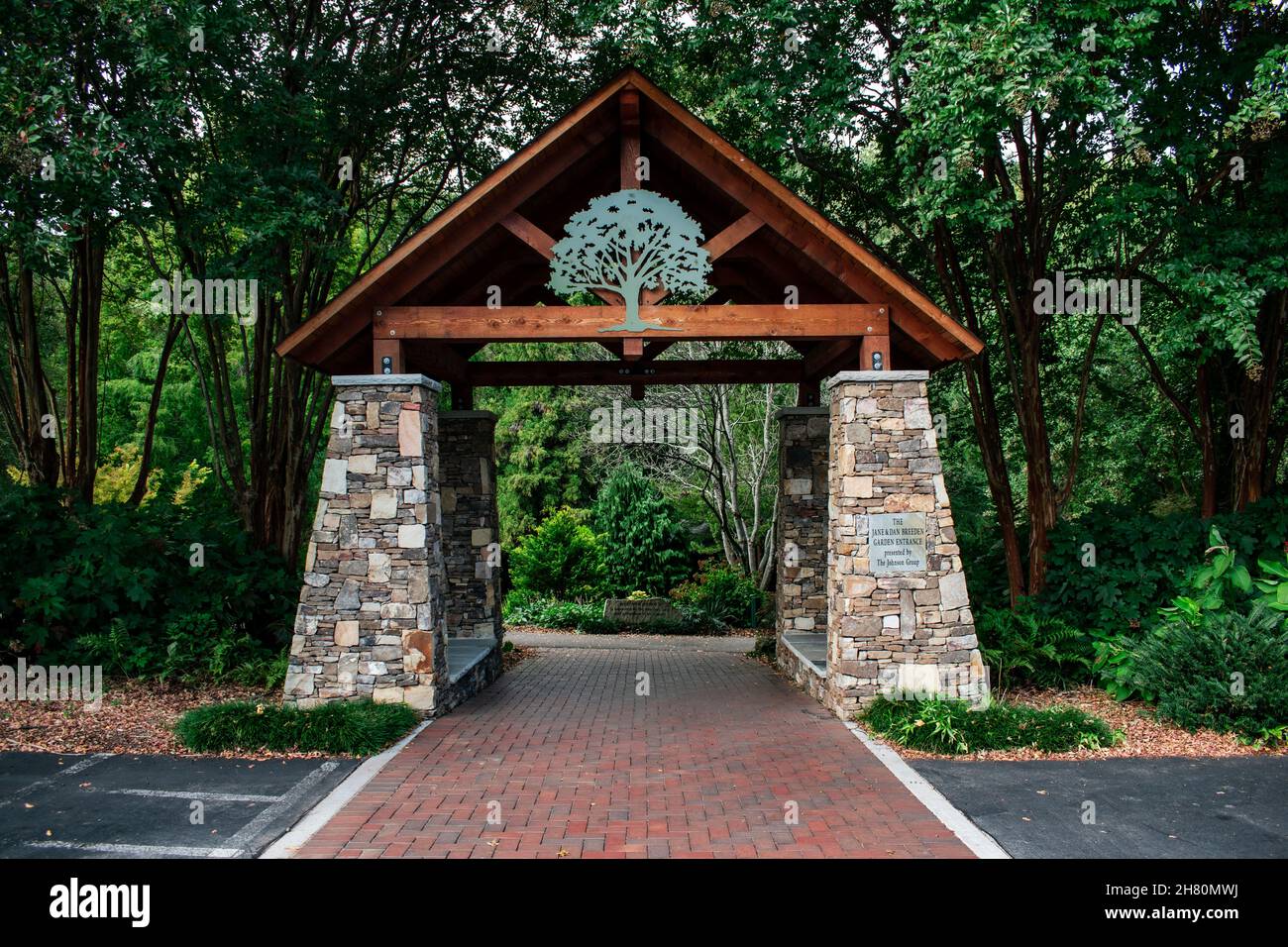 Entrance of a park with a tree symbol on it Stock Photo - Alamy