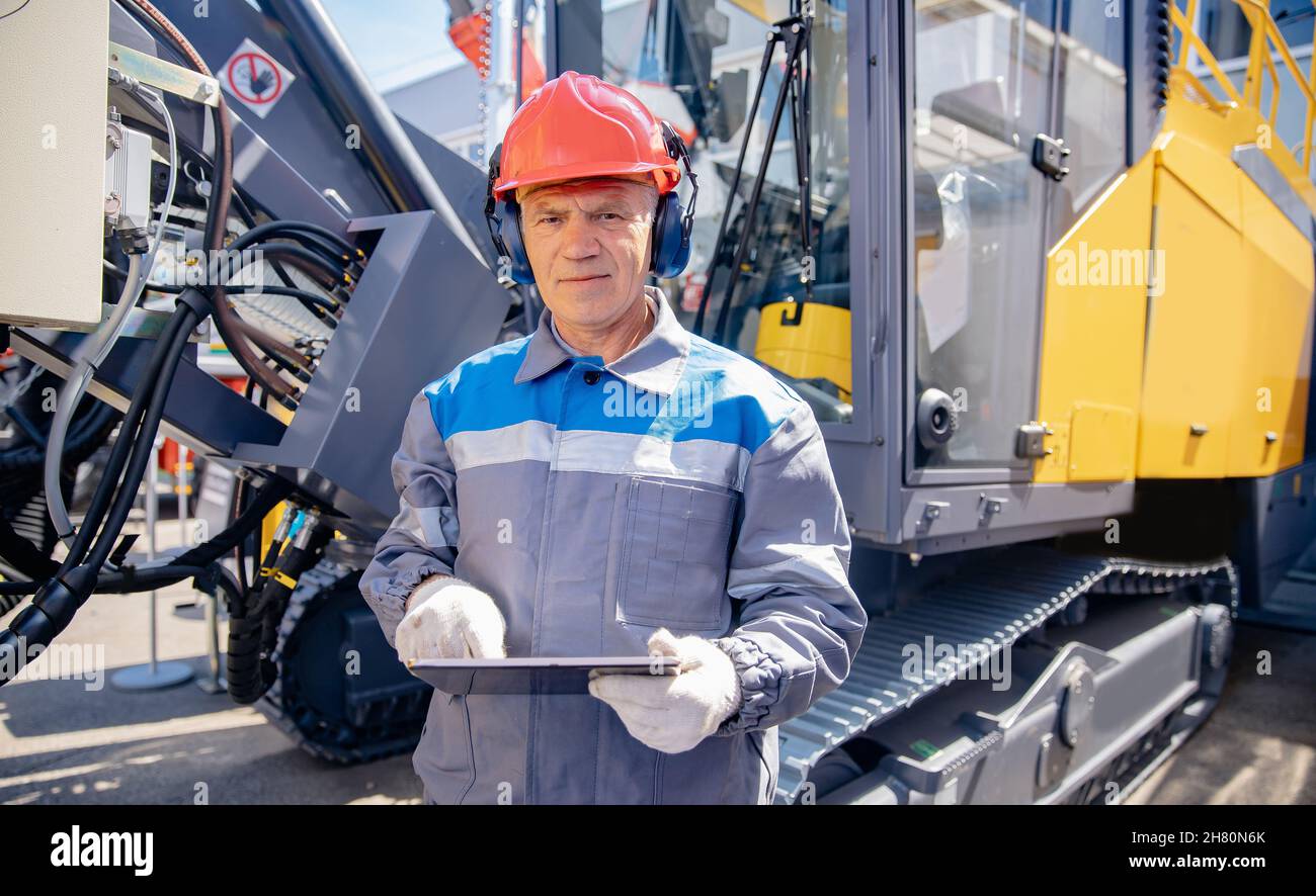 Industry operator use mobile tablet for control drilling rig for ...