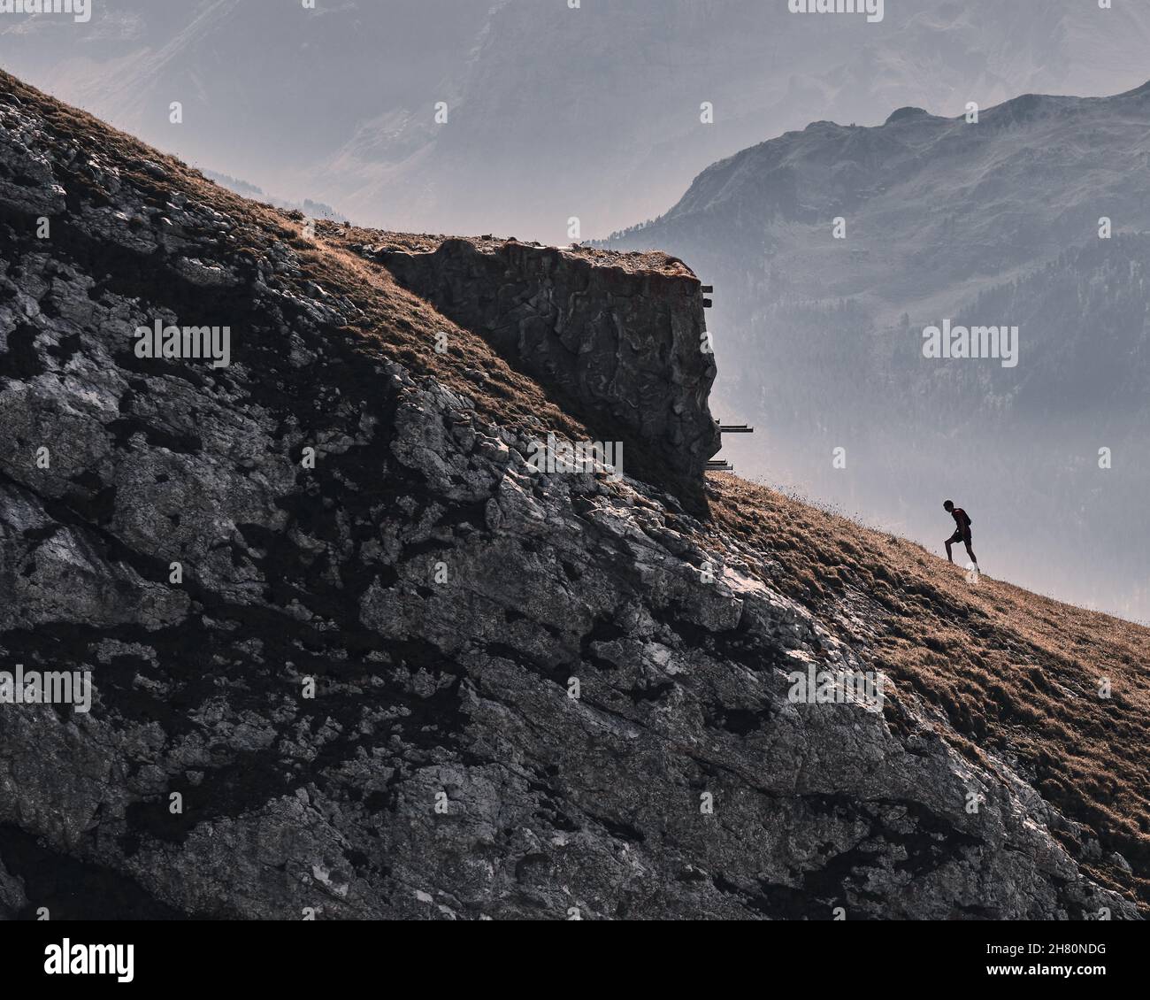 Beautiful view of a hiker climbing up a Mountain at the Mount Pilatus ...