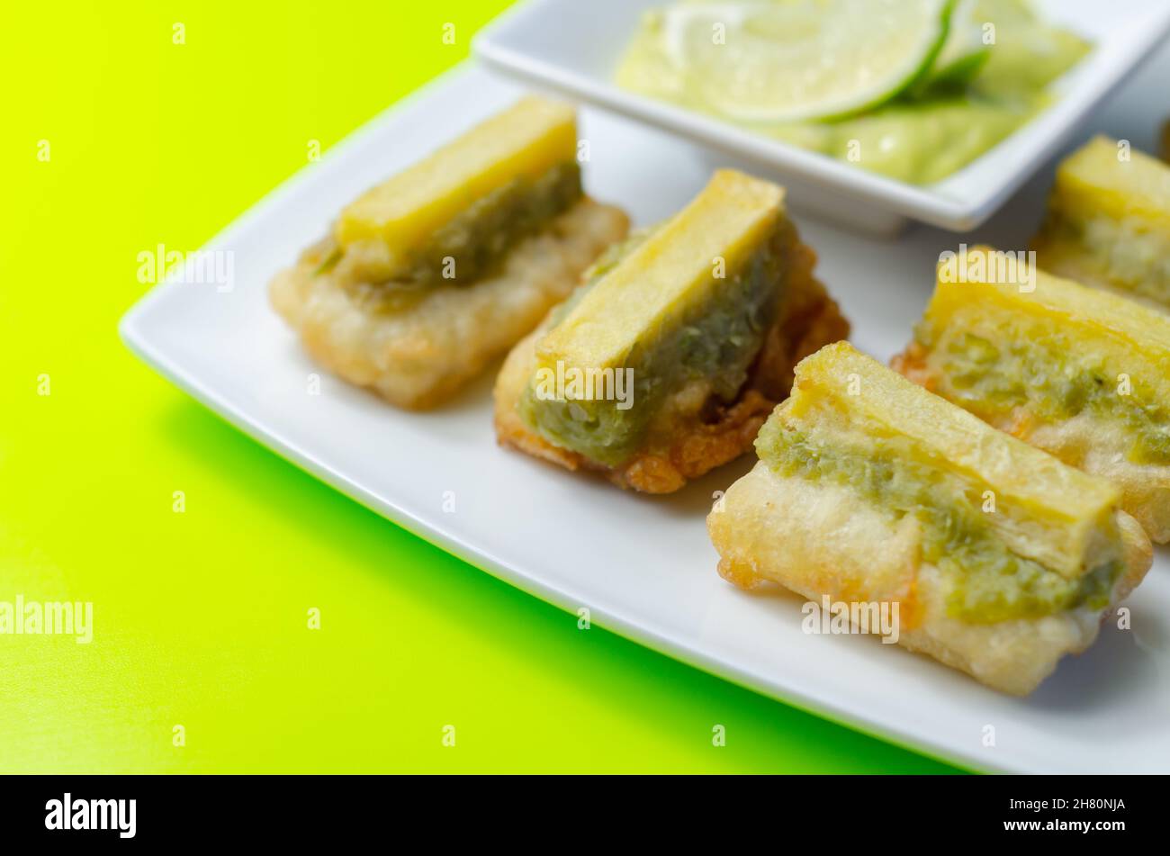 Skinless and boneless battered Alaska Pollock fillet pieces, topped ...