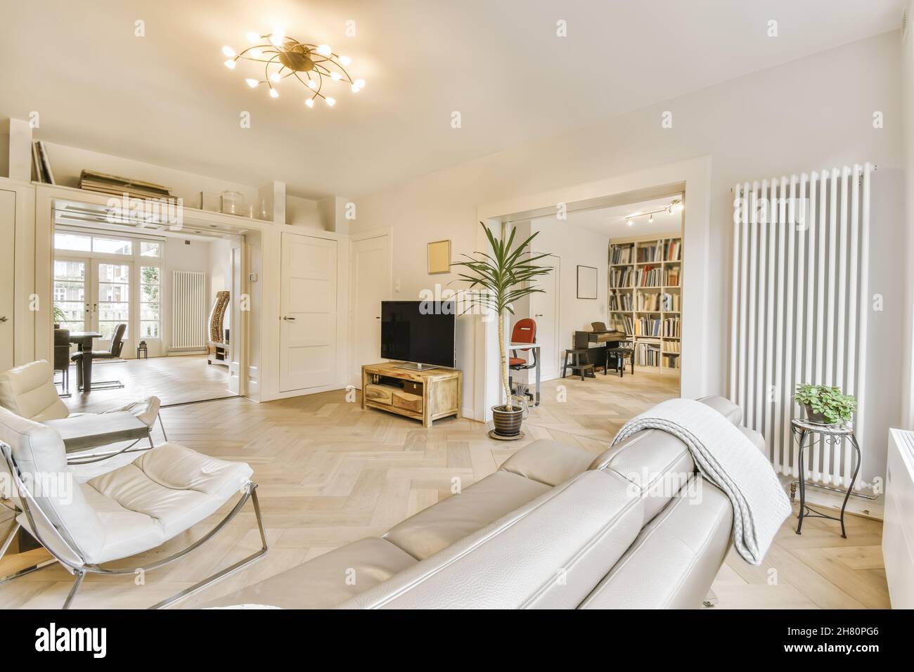 Large cozy living room with a large white sofa Stock Photo - Alamy
