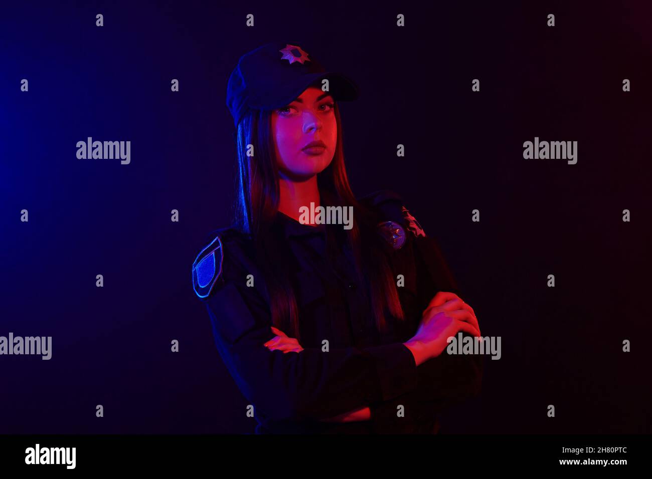 Close-up portrait of a female police officer posing for the camera ...