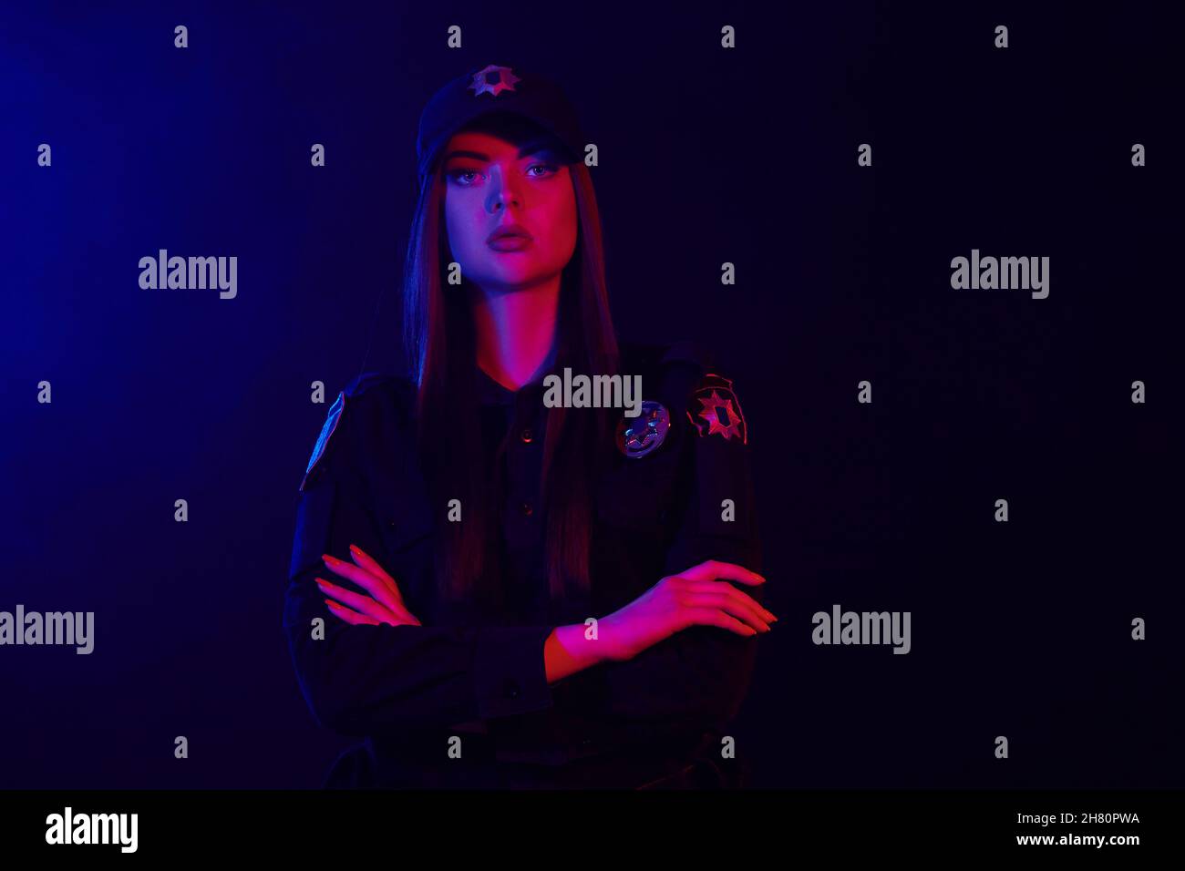 Close-up portrait of a female police officer posing for the camera ...