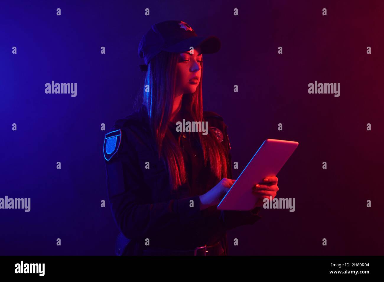 Close-up portrait of a female police officer posing for the camera ...