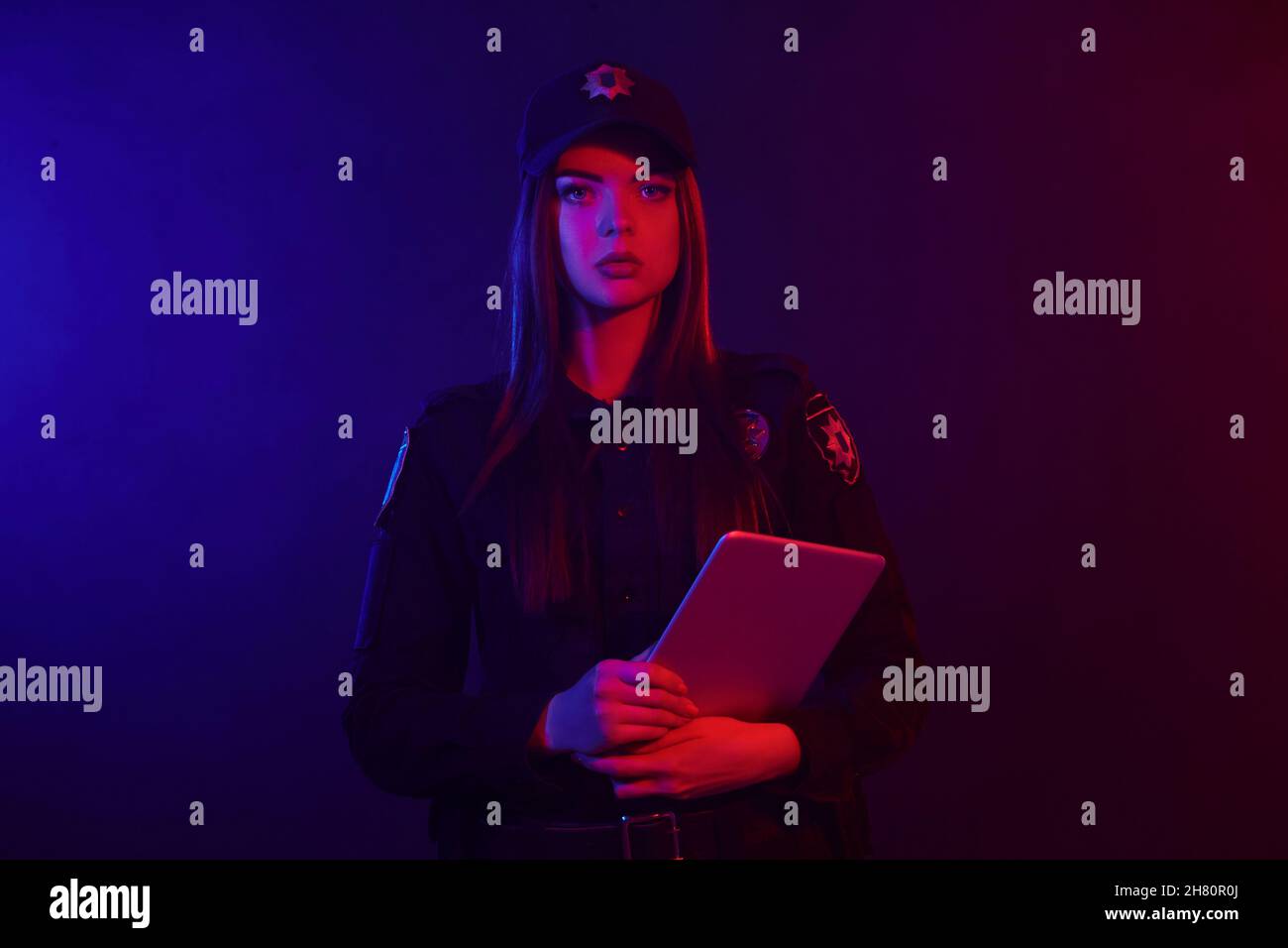 Close-up portrait of a female police officer posing for the camera ...