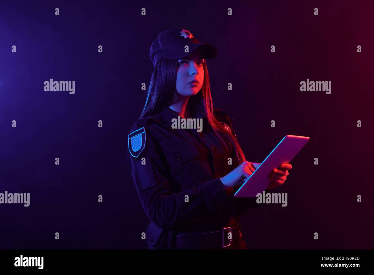 Close-up portrait of a female police officer posing for the camera ...