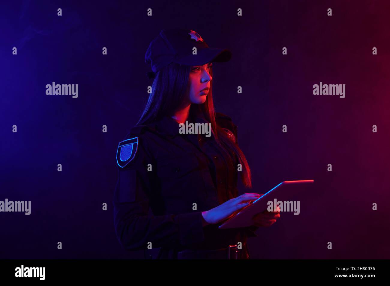 Close-up portrait of a female police officer posing for the camera ...