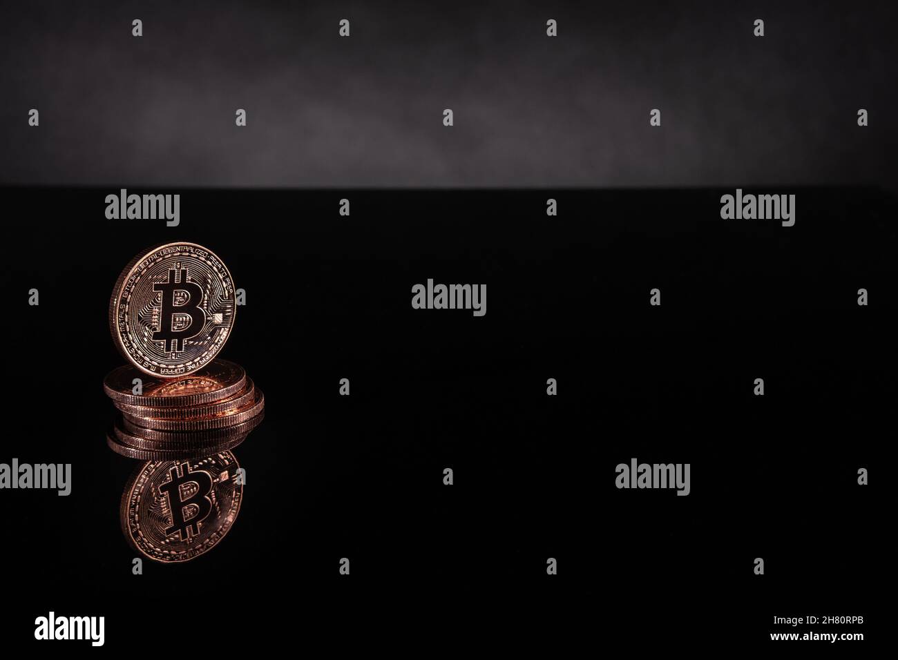 Bitcoin gold coins on a mirror surface with gray background Stock Photo ...