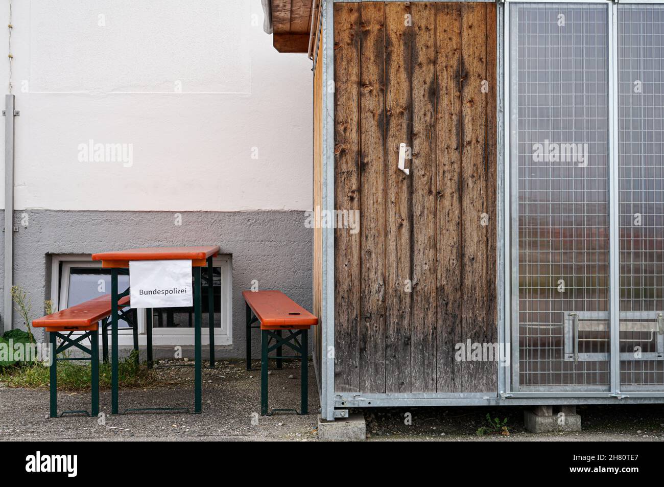 A group of benches and a table near the station, handwritten with a ...