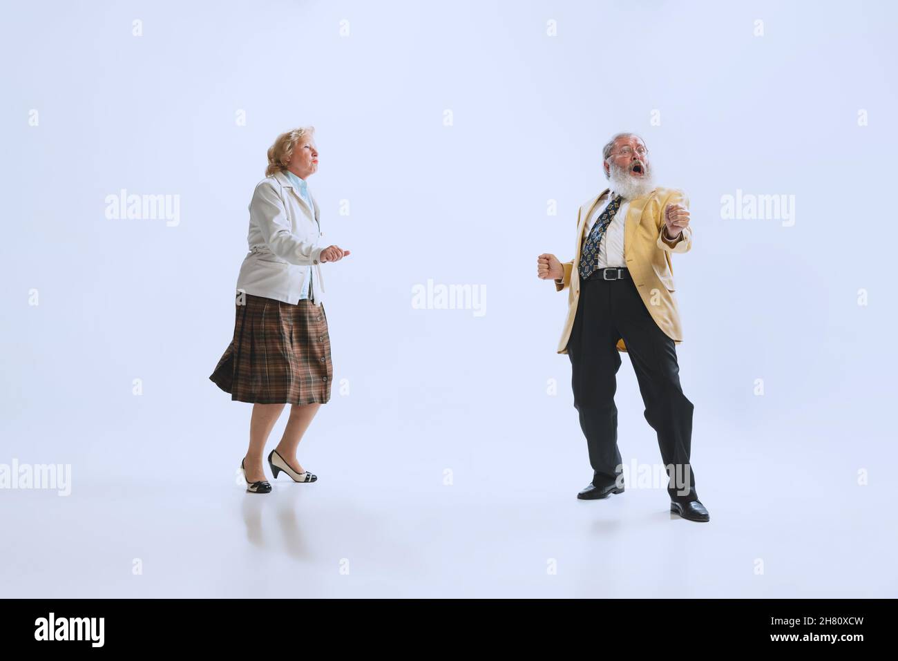 Dynamic portrait of retro style dancers, senior man and woman in ...