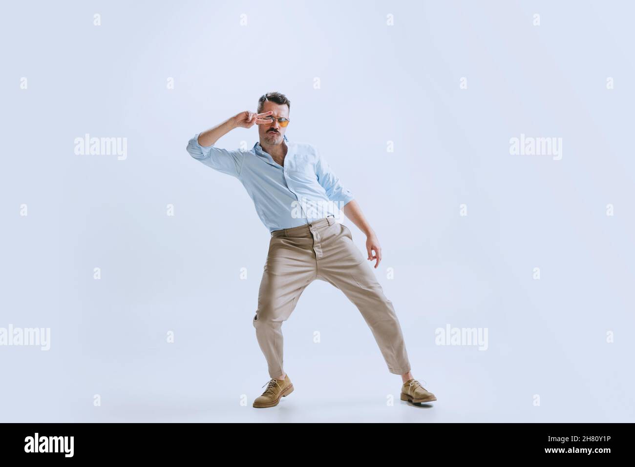 Portrai of young man, hipster or dandy dancing rock-and-roll or swing ...