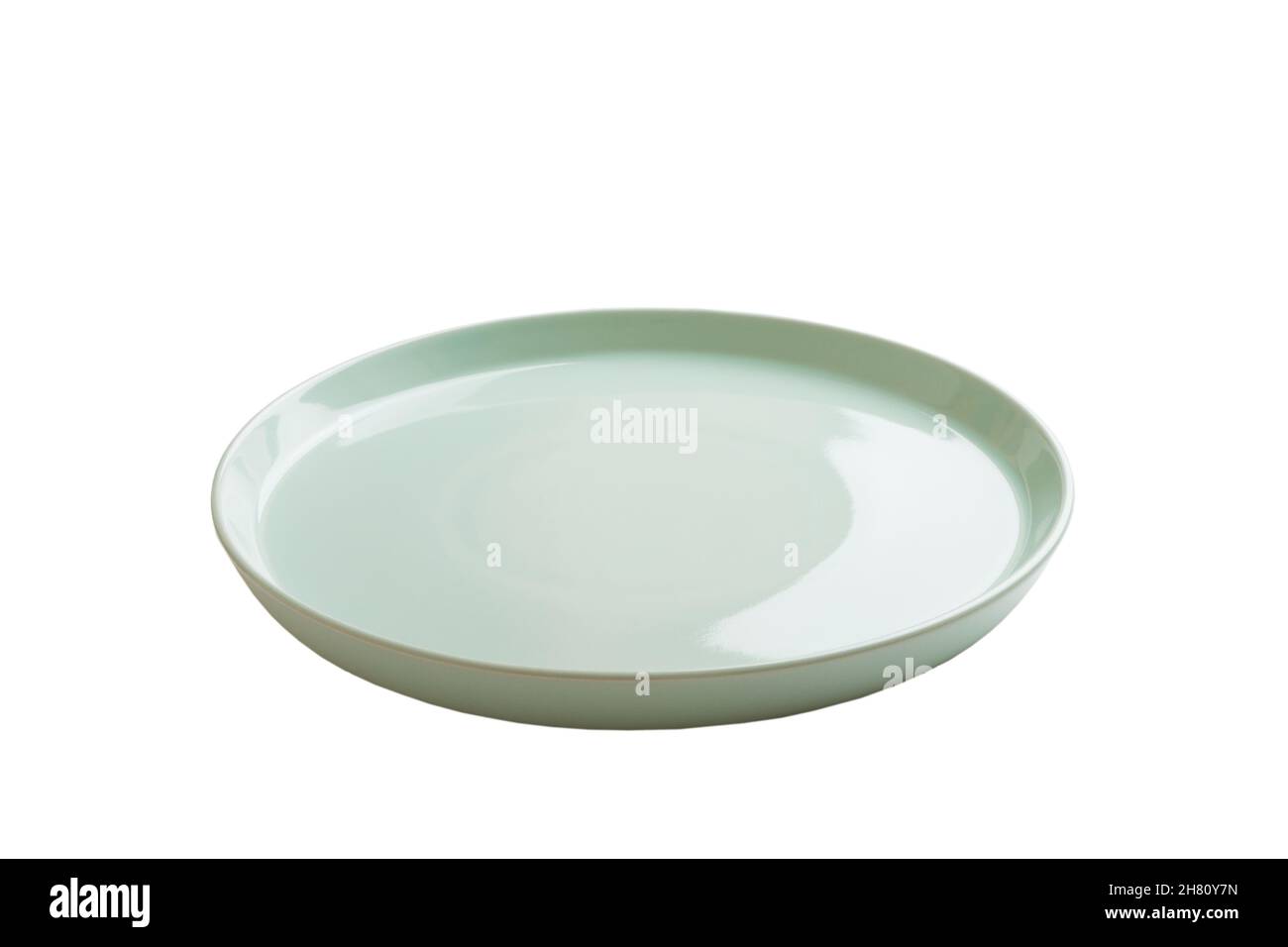Blue ceramic round plate isolated over white background. perspective ...