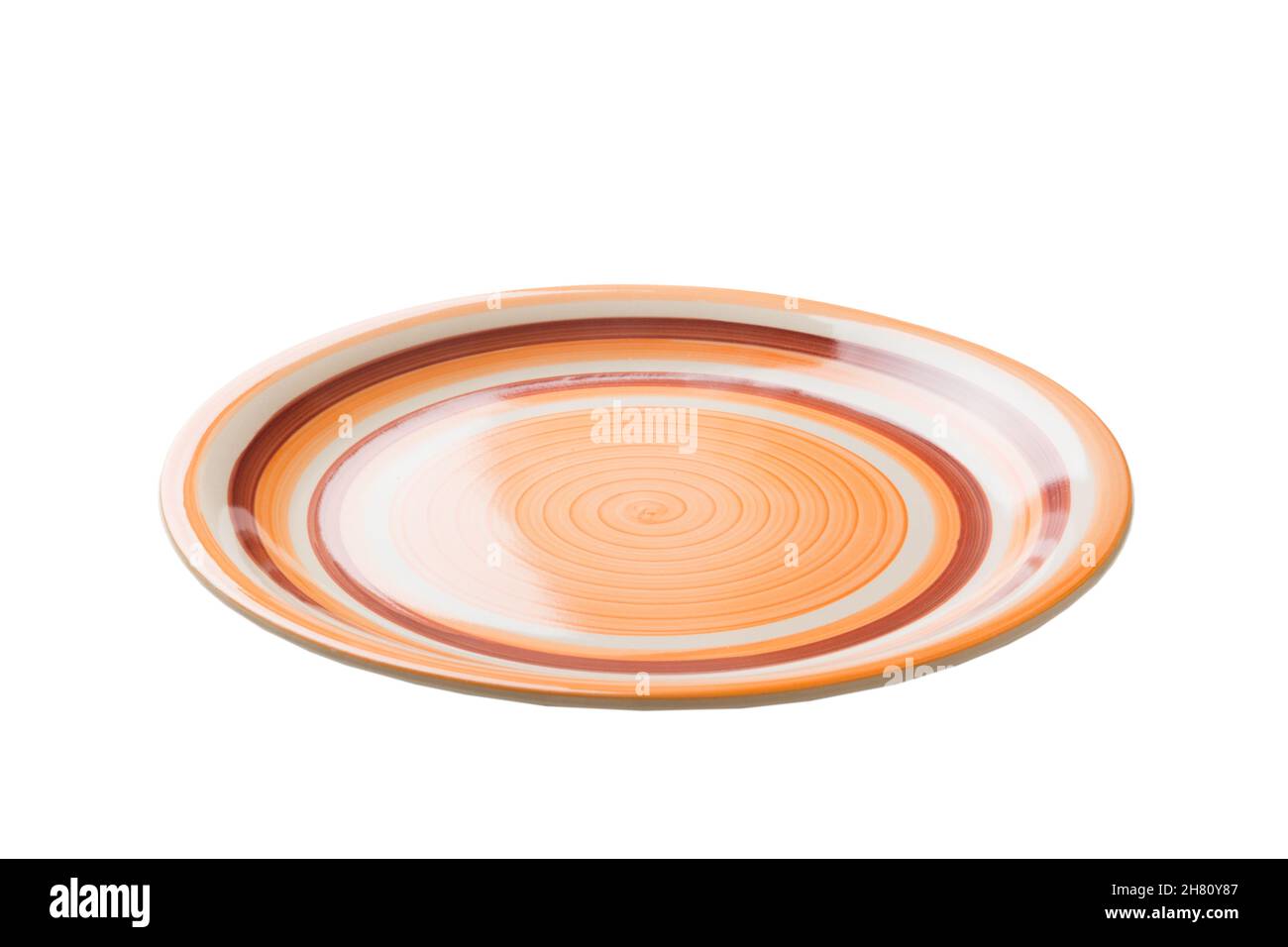 Orange ceramic round plate isolated over white background. perspective ...