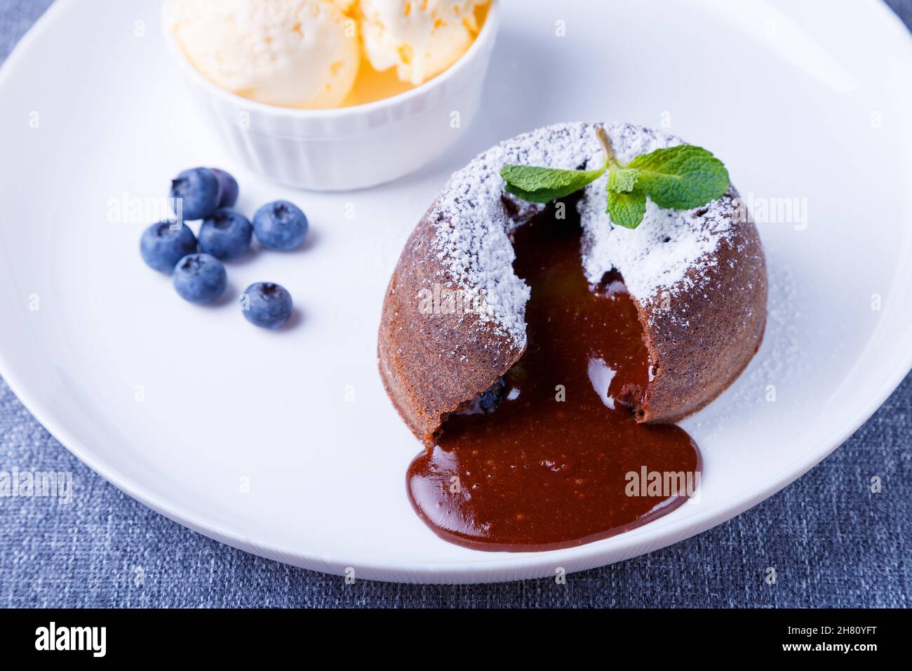 Lava cake with dripping filling. Chocolate fondant cake with vanilla ...