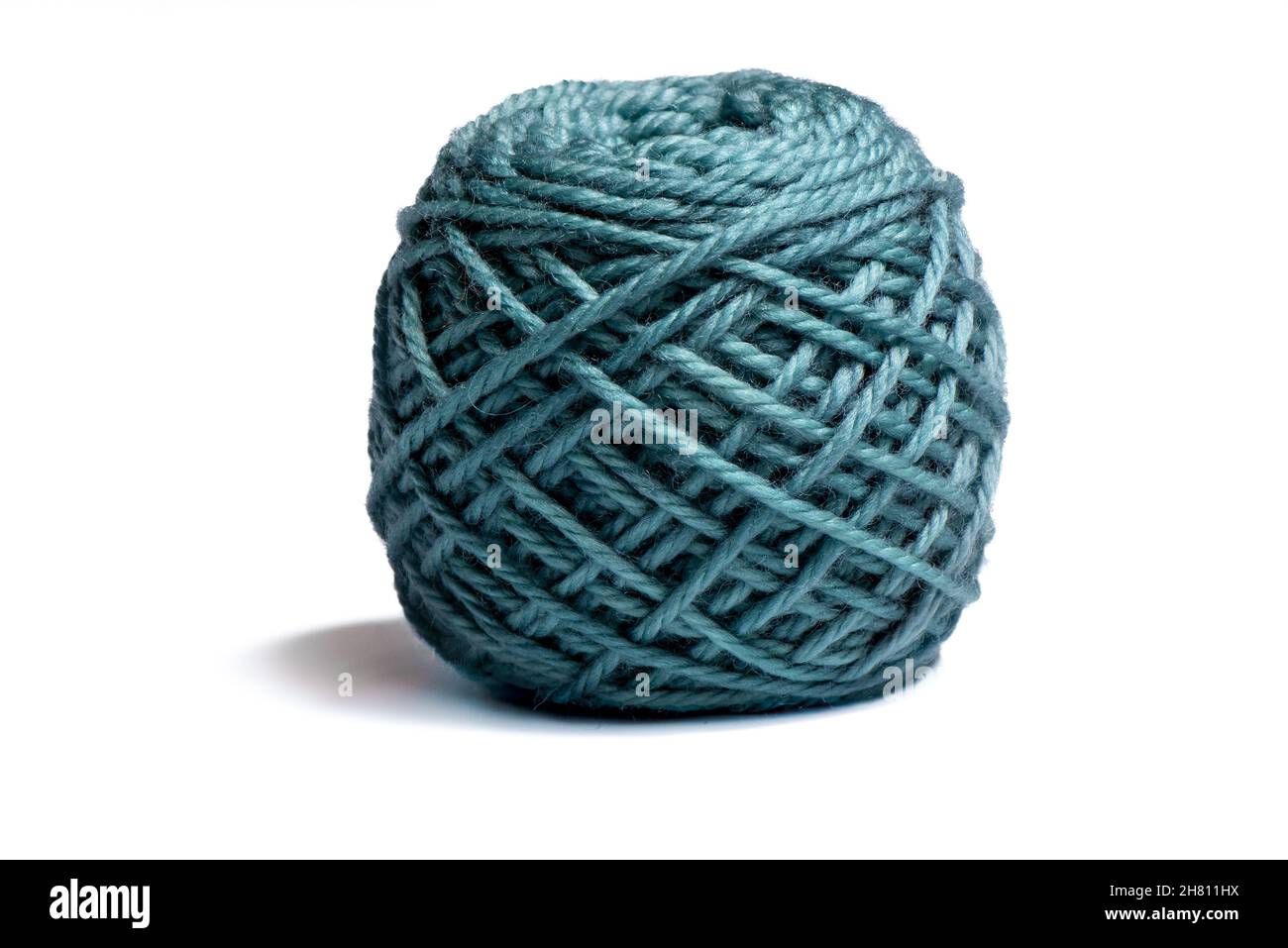 Ball of blue teal yarn on a white background Stock Photo - Alamy