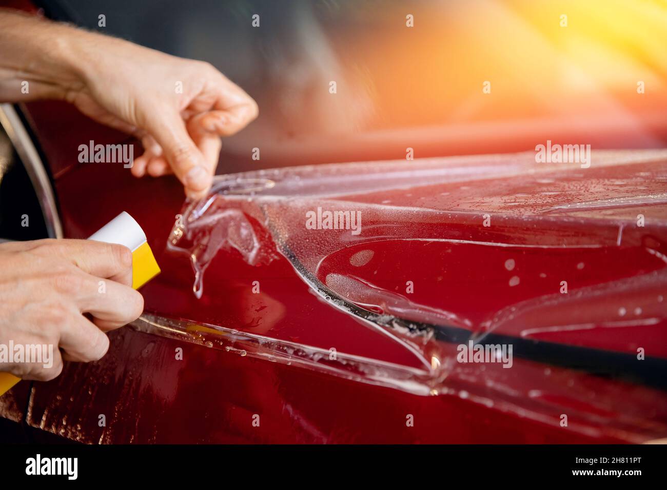 Concept Transparent protection for paint. Process of pasting hood of ...