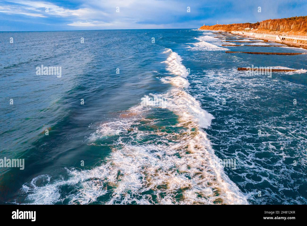 Foamy wave of clear turquoise ocean water near sandy shore, Aerial top ...