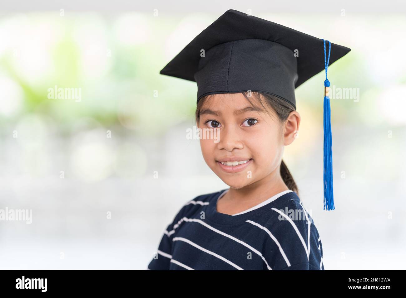 Shallow focus shot of a happy Thai kid with a graduation hat Stock ...
