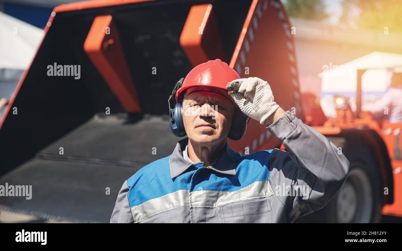 Bulldozer driver coal mine in uniform with helmet and headphones ...