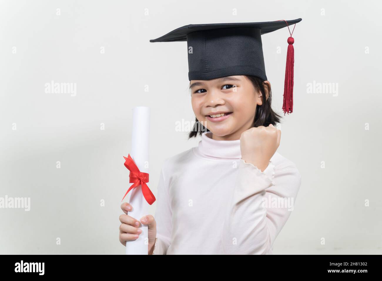 Happy Thai kid with a graduation hat and diploma isolated on white ...