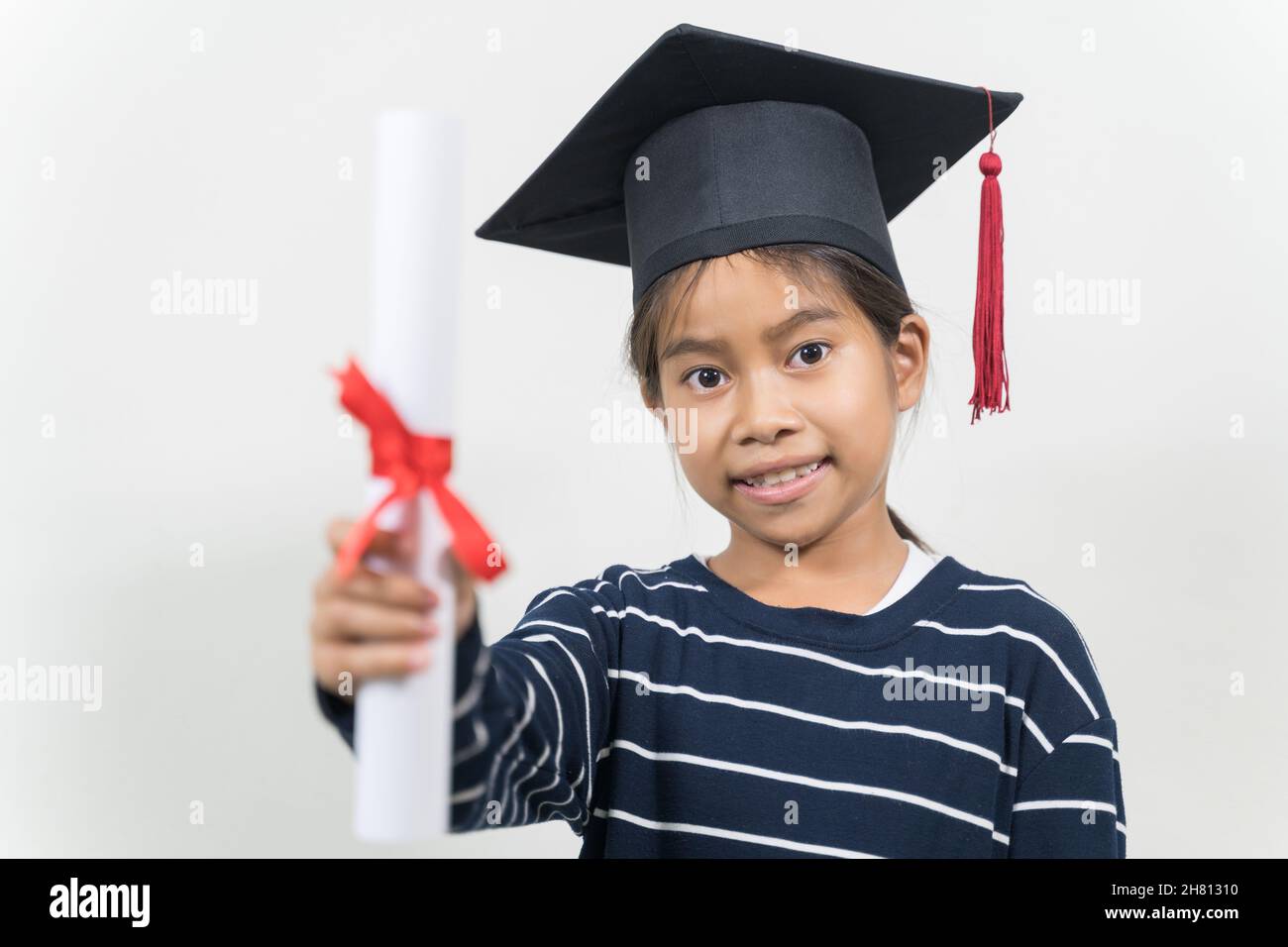 Happy Thai kid with a graduation hat and diploma isolated on white ...