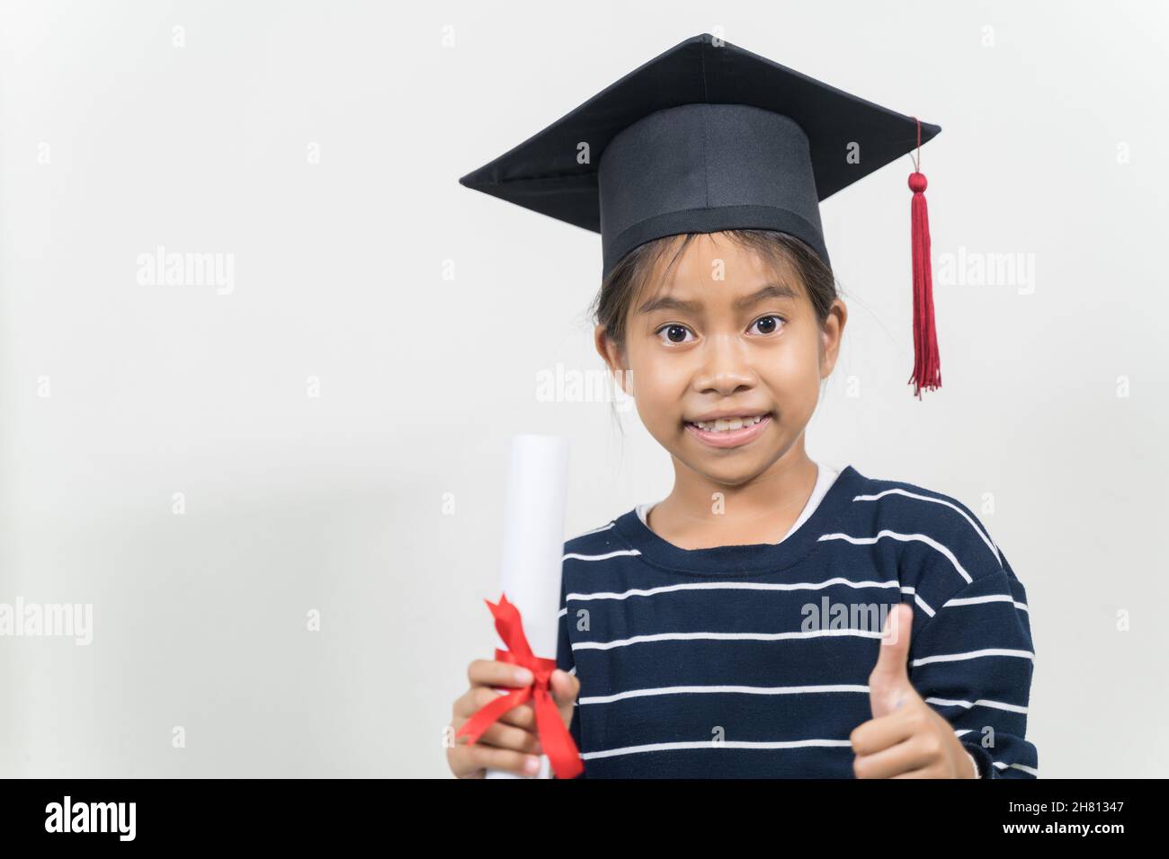 Happy Thai kid with a graduation hat and diploma isolated on white ...