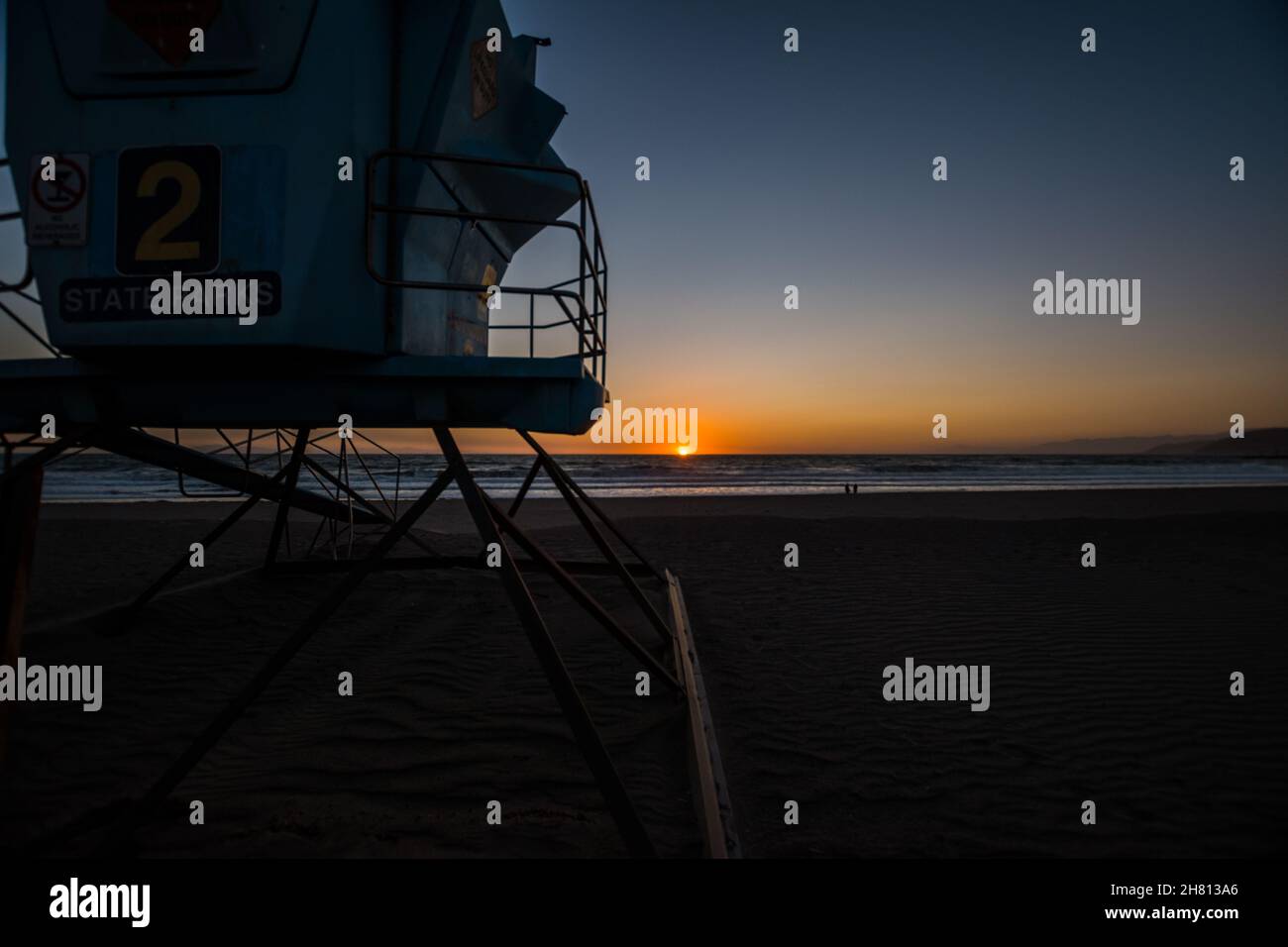 Lifeguard tower on the beach at sunset Stock Photo - Alamy