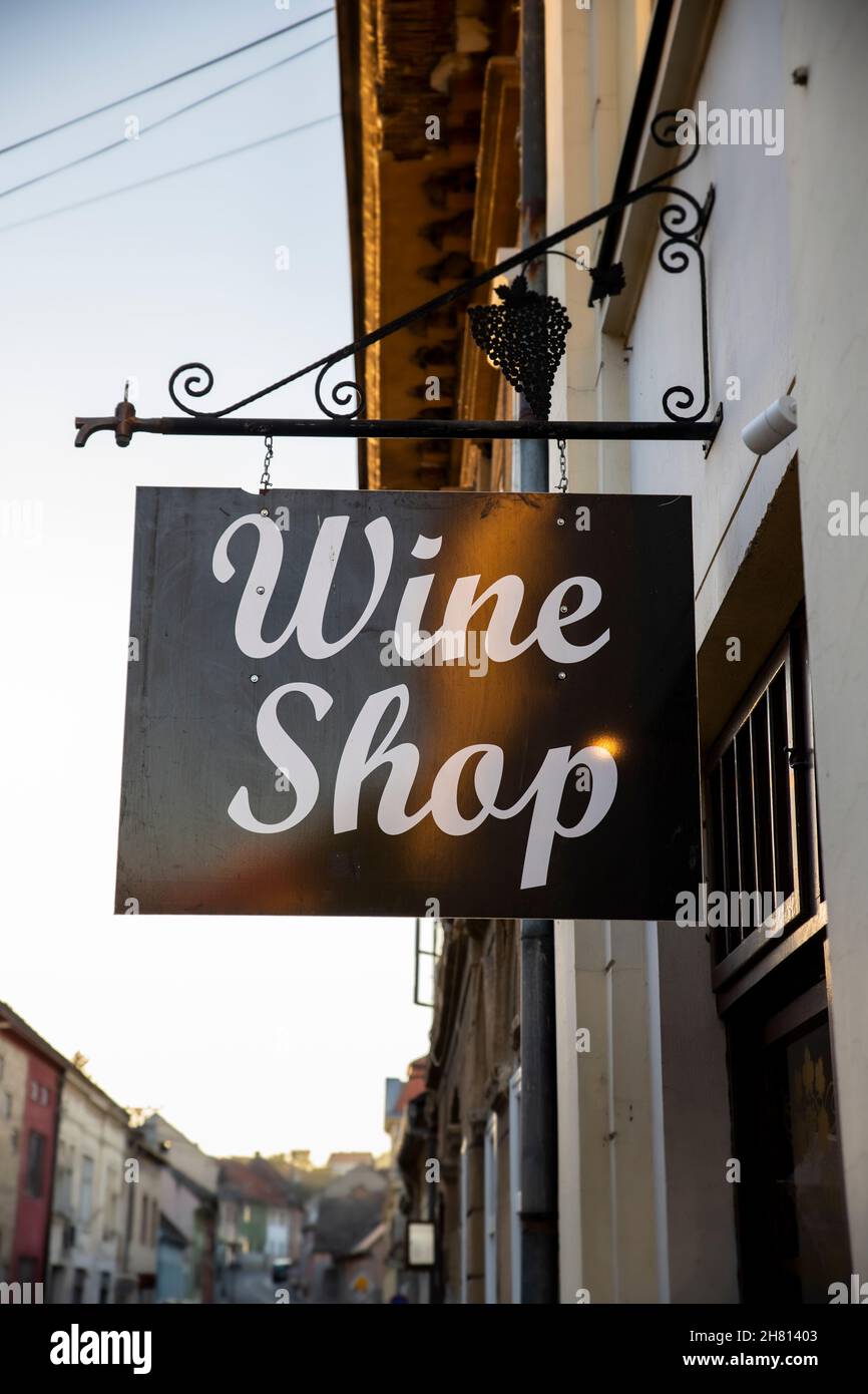 Wine shop sign hanging from old building Stock Photo - Alamy