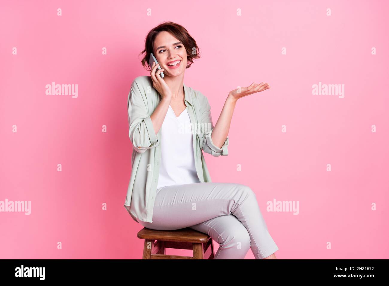 Photo of cute bob hairdo millennial lady talk telephone wear grey green ...