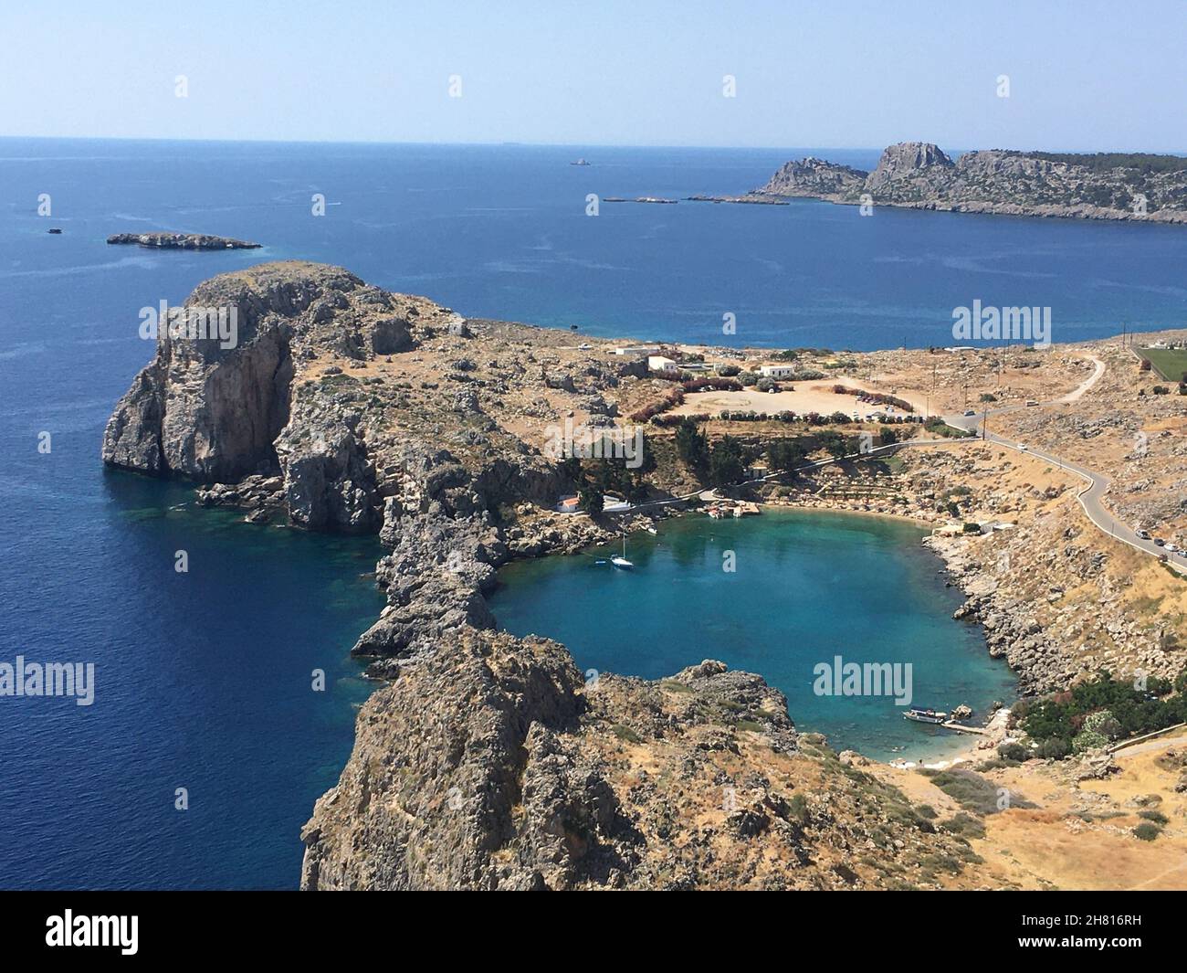 Scenic rocky beach near the sea in Lindos Acropolis Greece Stock Photo ...