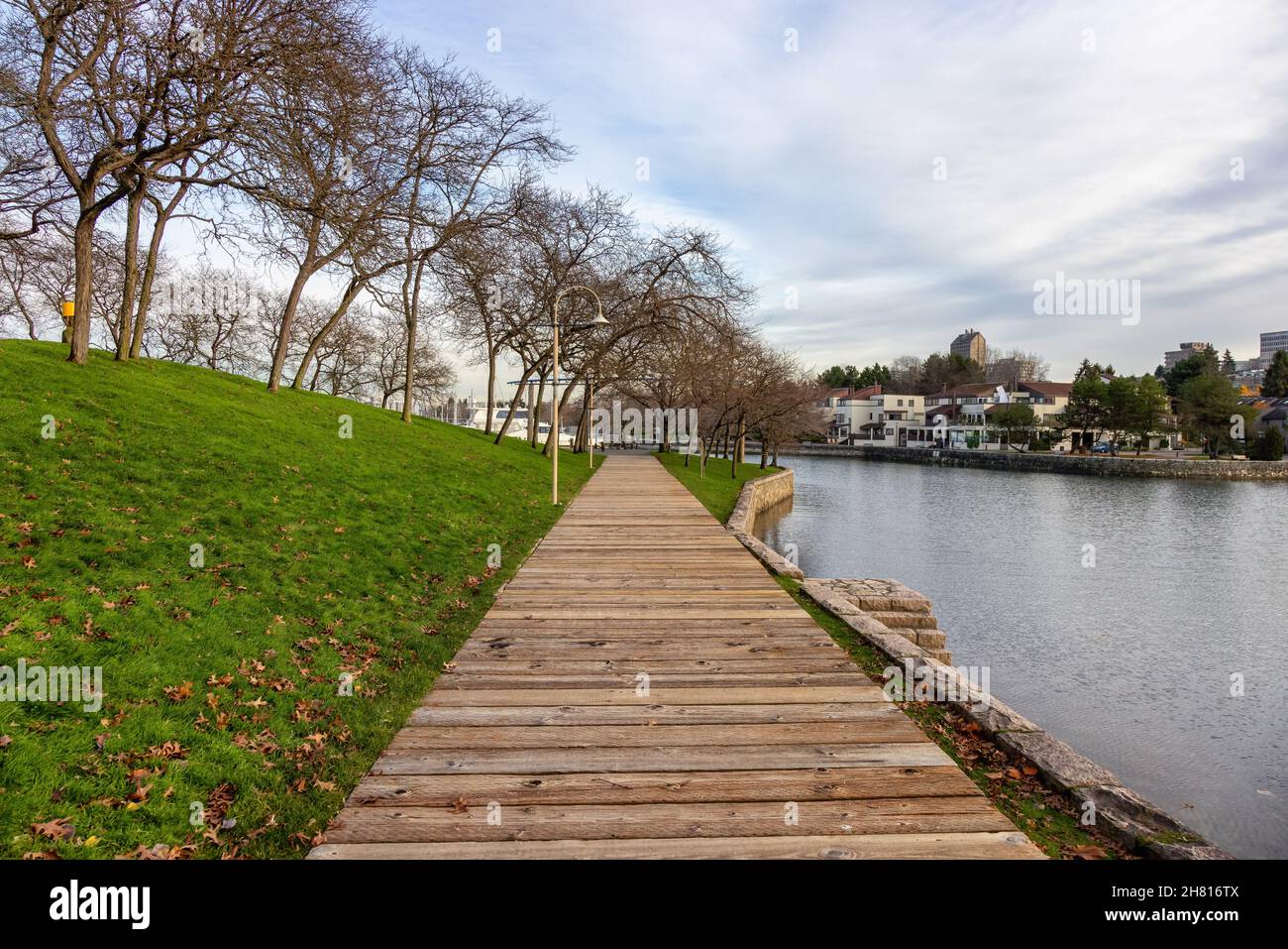 Wooden path in a modern city park during sunny fall season day Stock ...