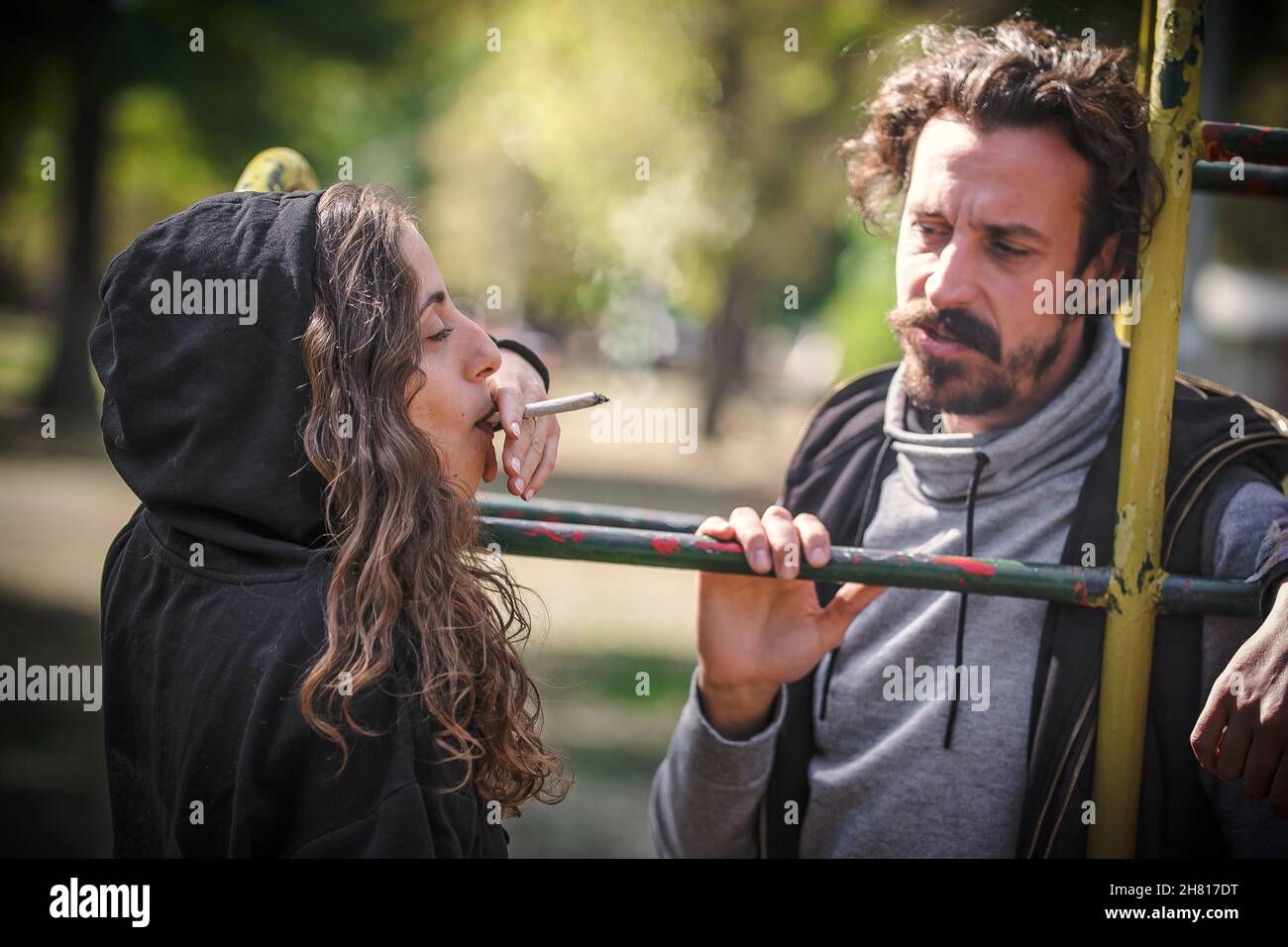 Young couple, woman and man, smoking cannabis marijuana ganja or ...