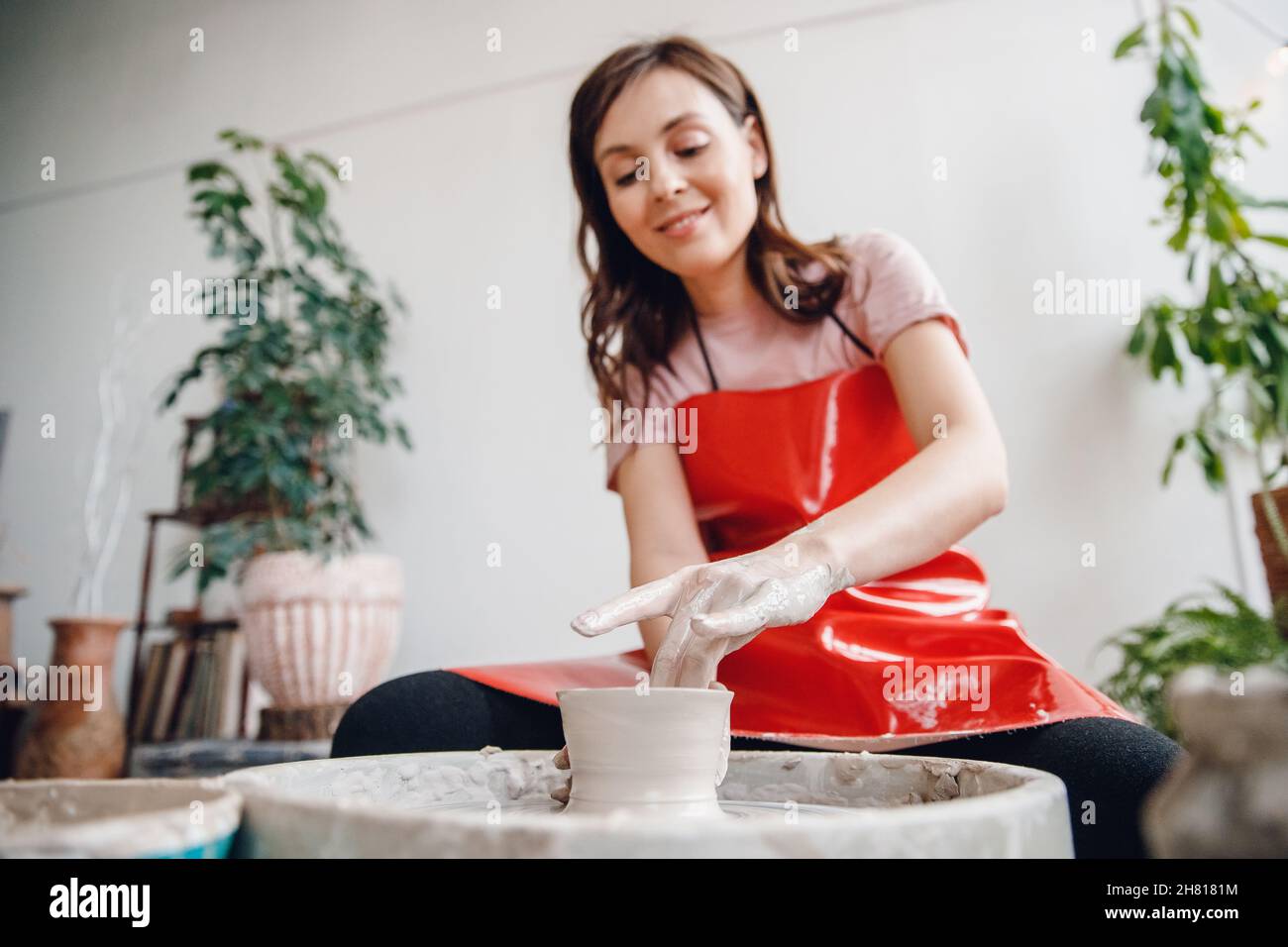 Beautiful potter girl makes pottery for roasting in oven. Concept ...