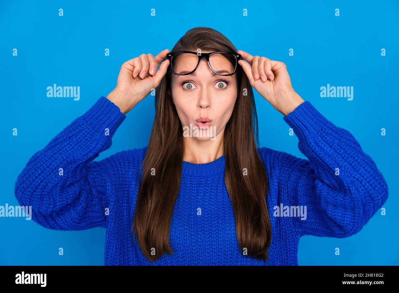 Portrait Of Attractive Amazed Girlish Brown Haired Girl Touching Specs