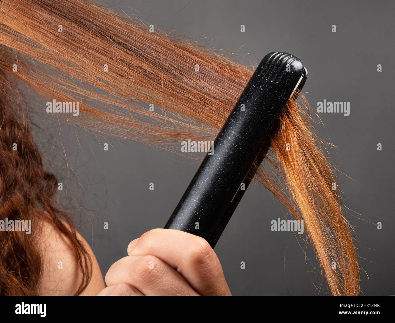 hair straightening with an iron, hair care Stock Photo - Alamy